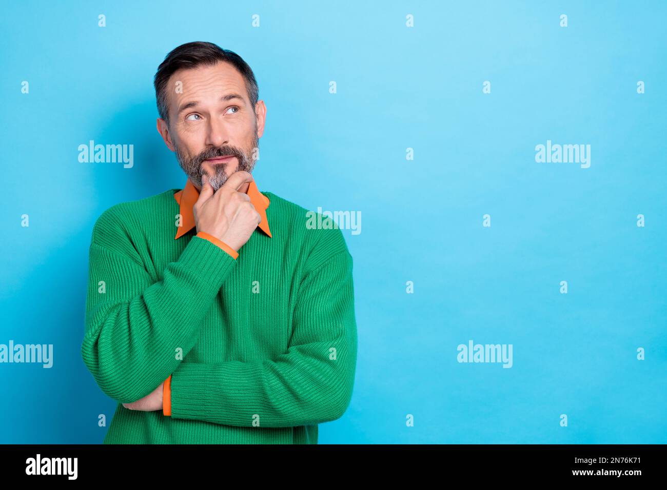 Photo of minded clever man arm touch chin look interested empty space ...