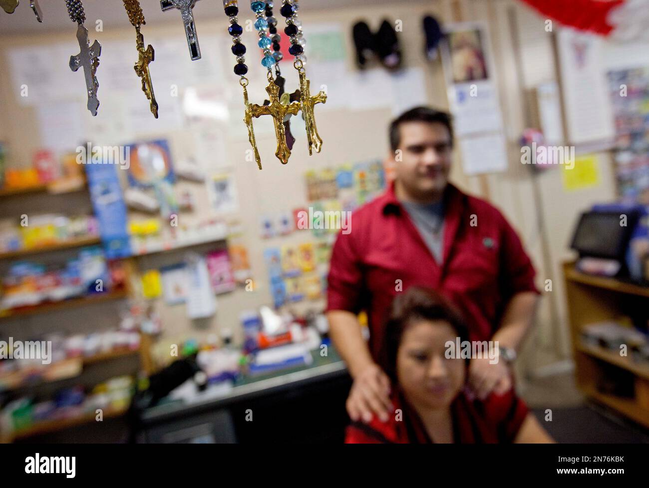 In this June 10, 2013 photo, crosses hang on display as Maria Barbosa's ...