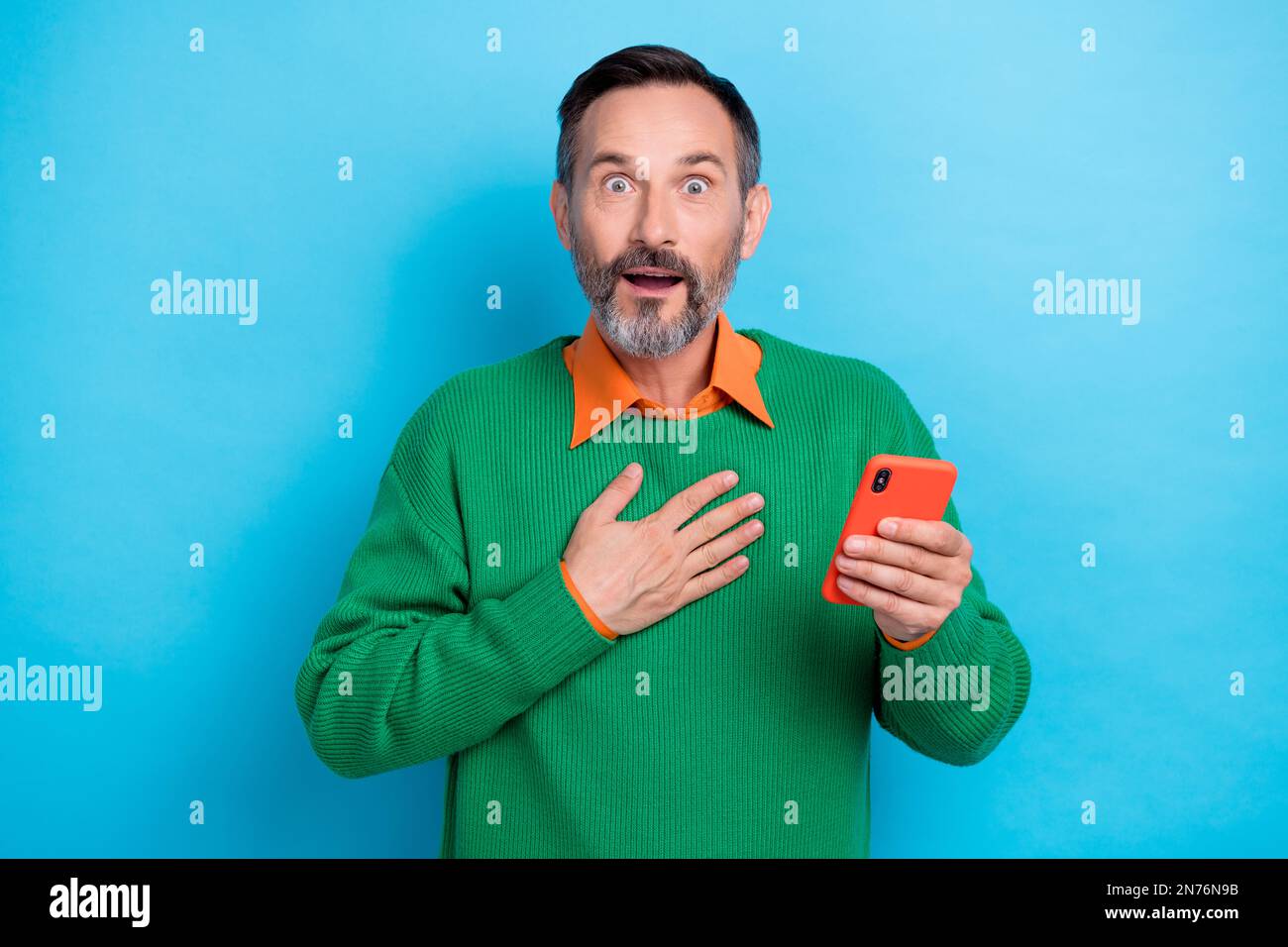 Photo of astonished person hold telephone hand touch chest open mouth ...