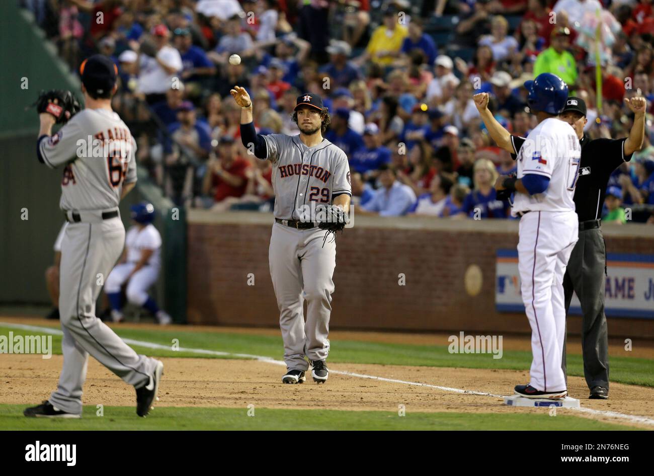 Houston Astros starting pitcher Lucas Harrell (64) takes the throw from ...