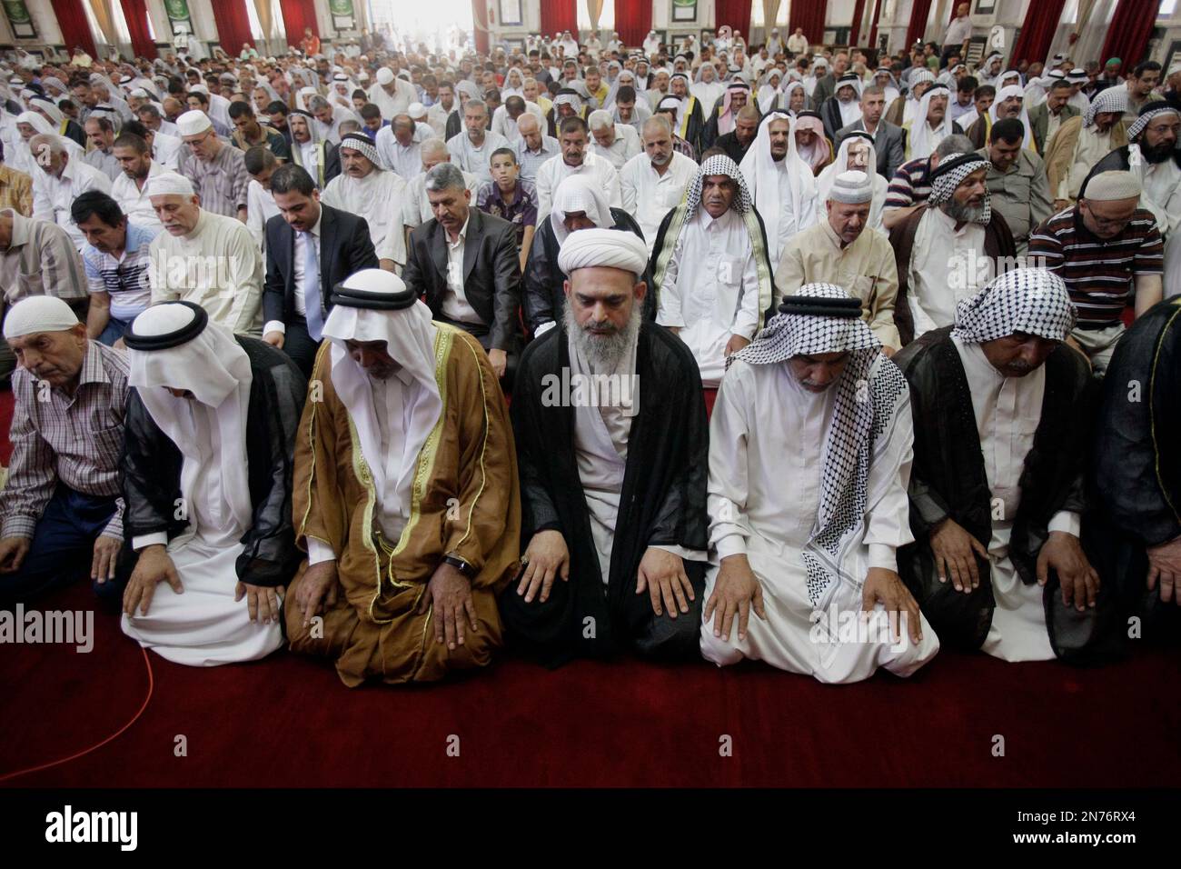 Worshippers attend joint Sunni-Shiite Friday prayers at Abdul-Qadir al ...