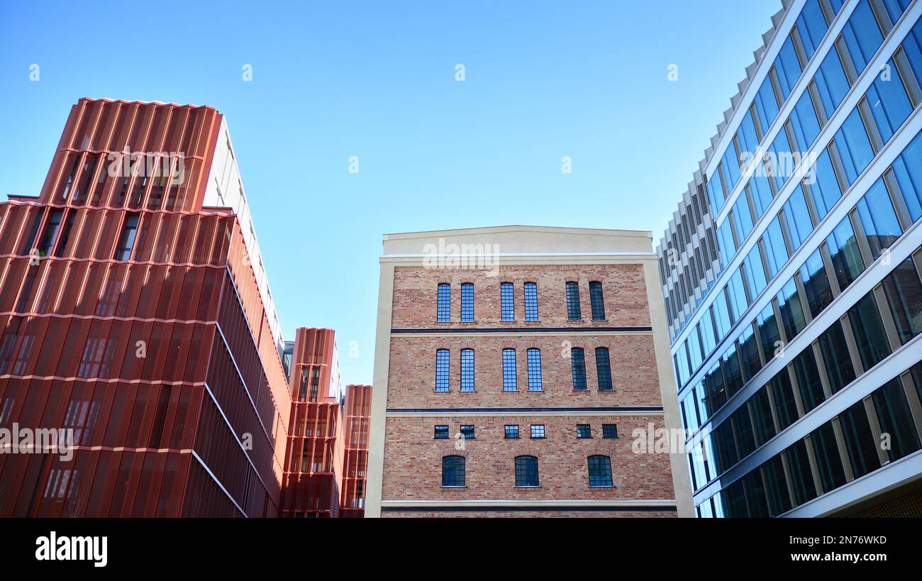 Revitalized red brick building and modern office building. Rising sun ...