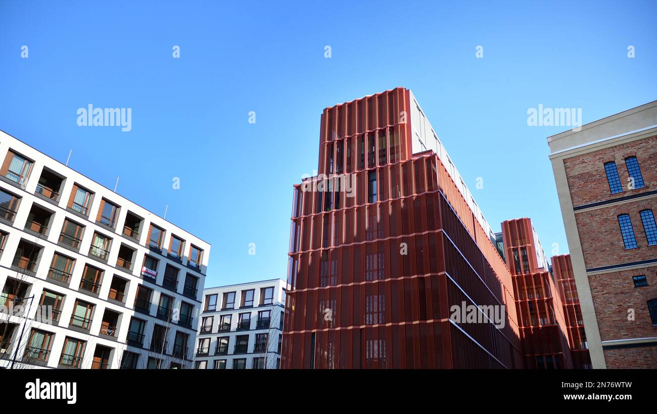 Revitalized red brick building and modern office building. Rising sun ...