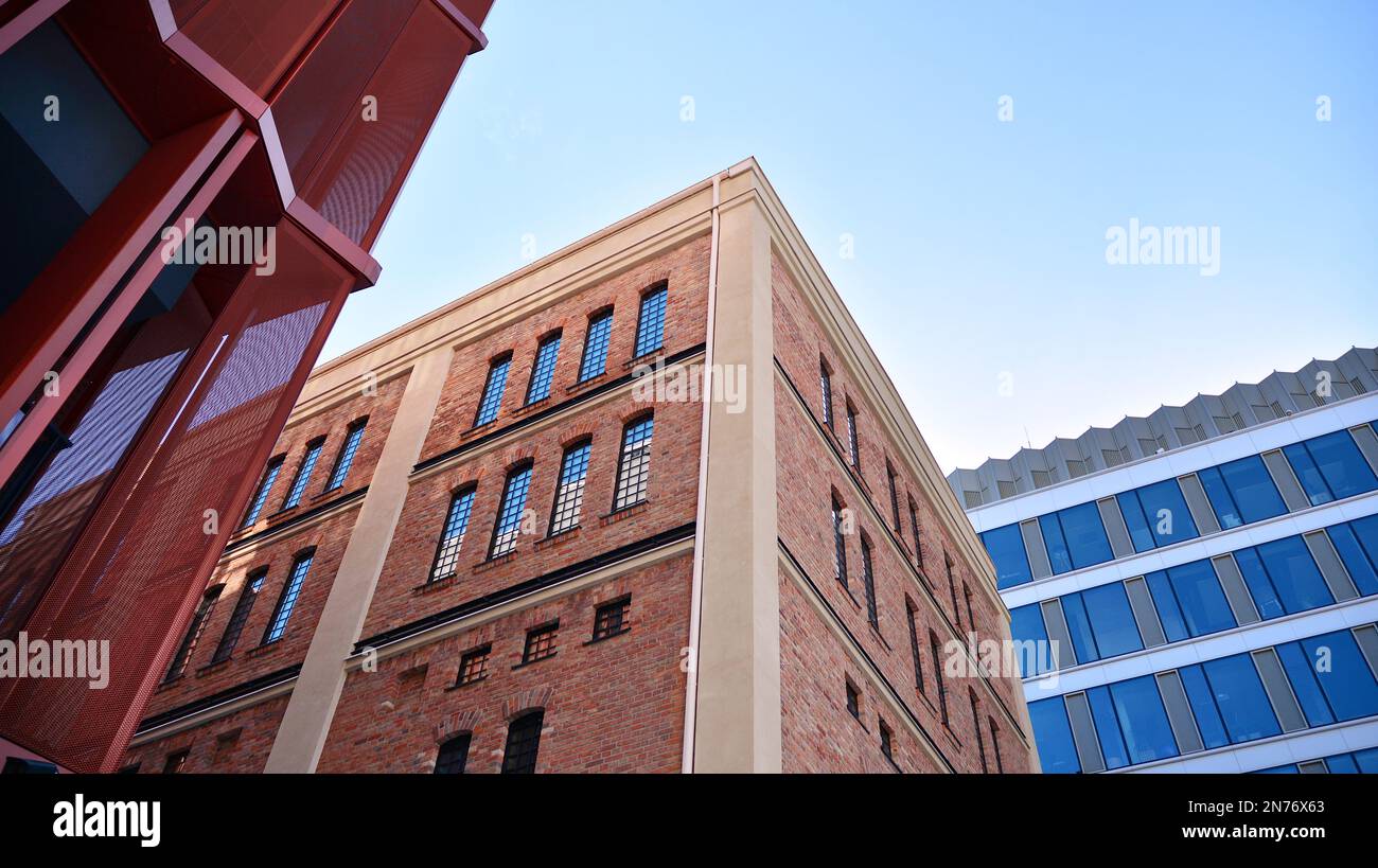 Revitalized red brick building and modern office building. Rising sun ...