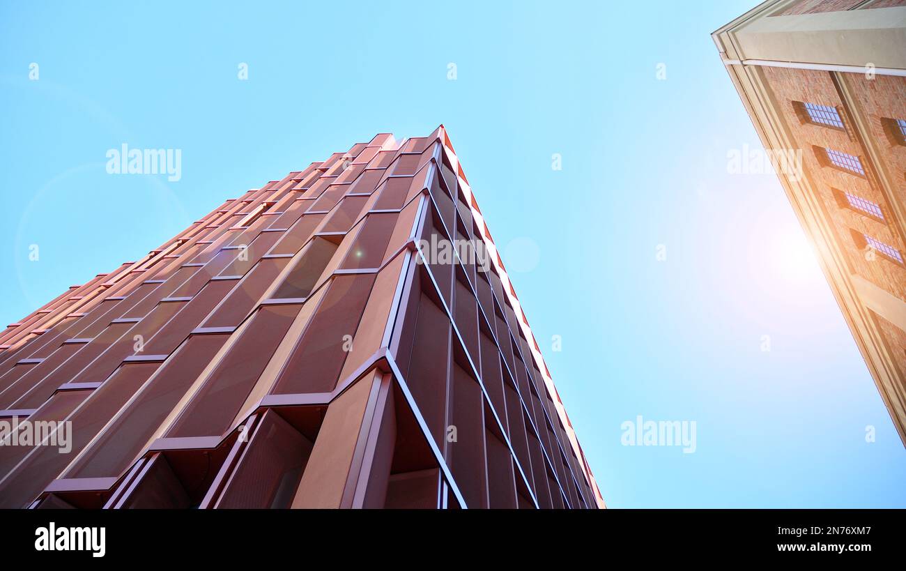 Revitalized red brick building and modern office building. Rising sun ...