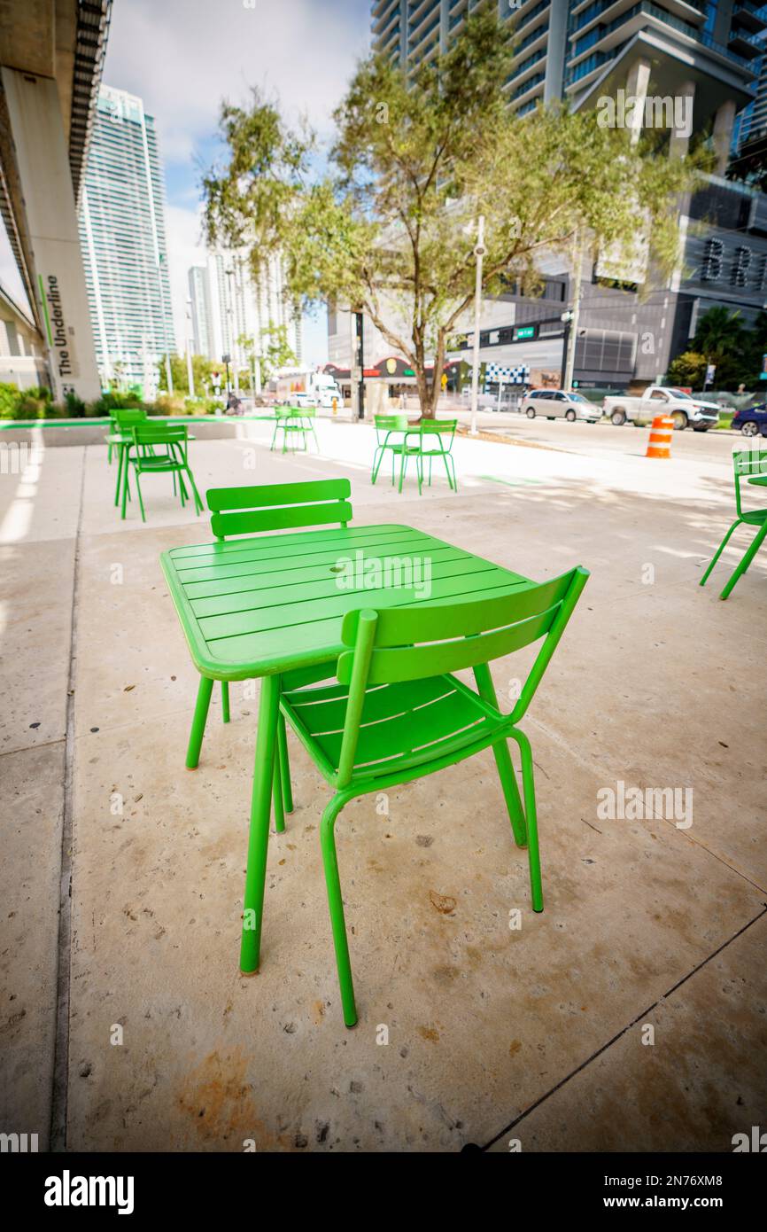 Public green tables and chairs at the Brickell Underline Miami Stock ...
