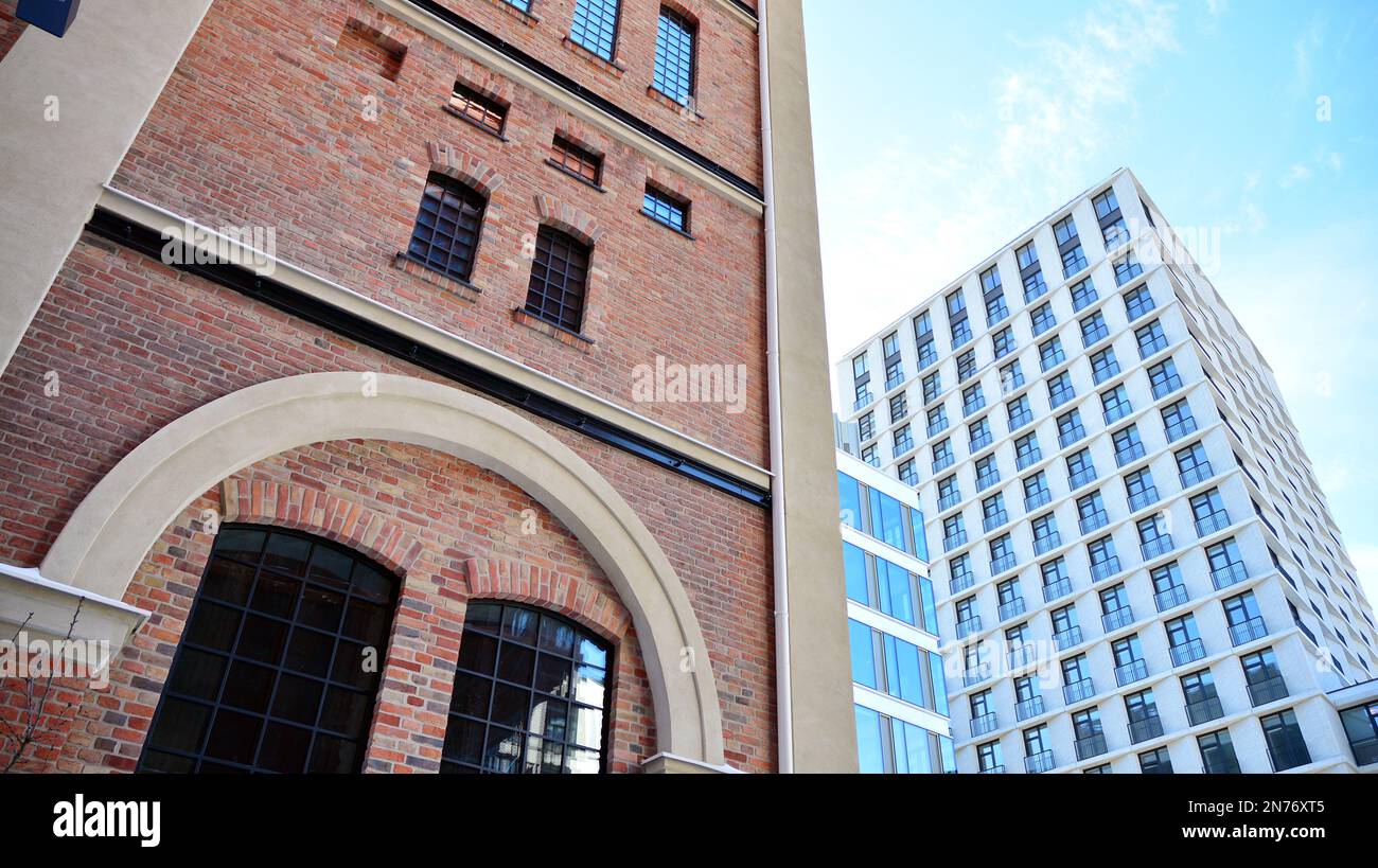 Revitalized red brick building and modern office building. Rising sun ...