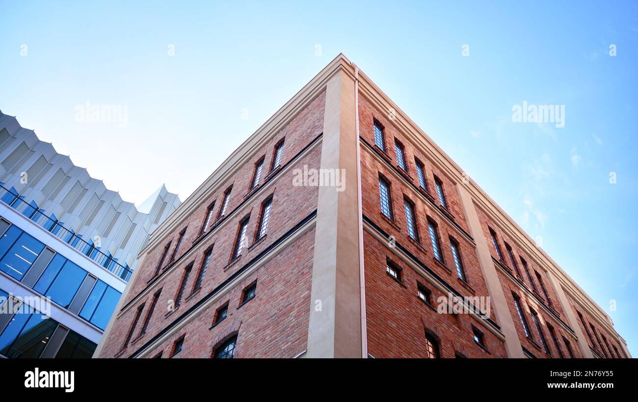 Revitalized red brick building and modern office building. Rising sun ...