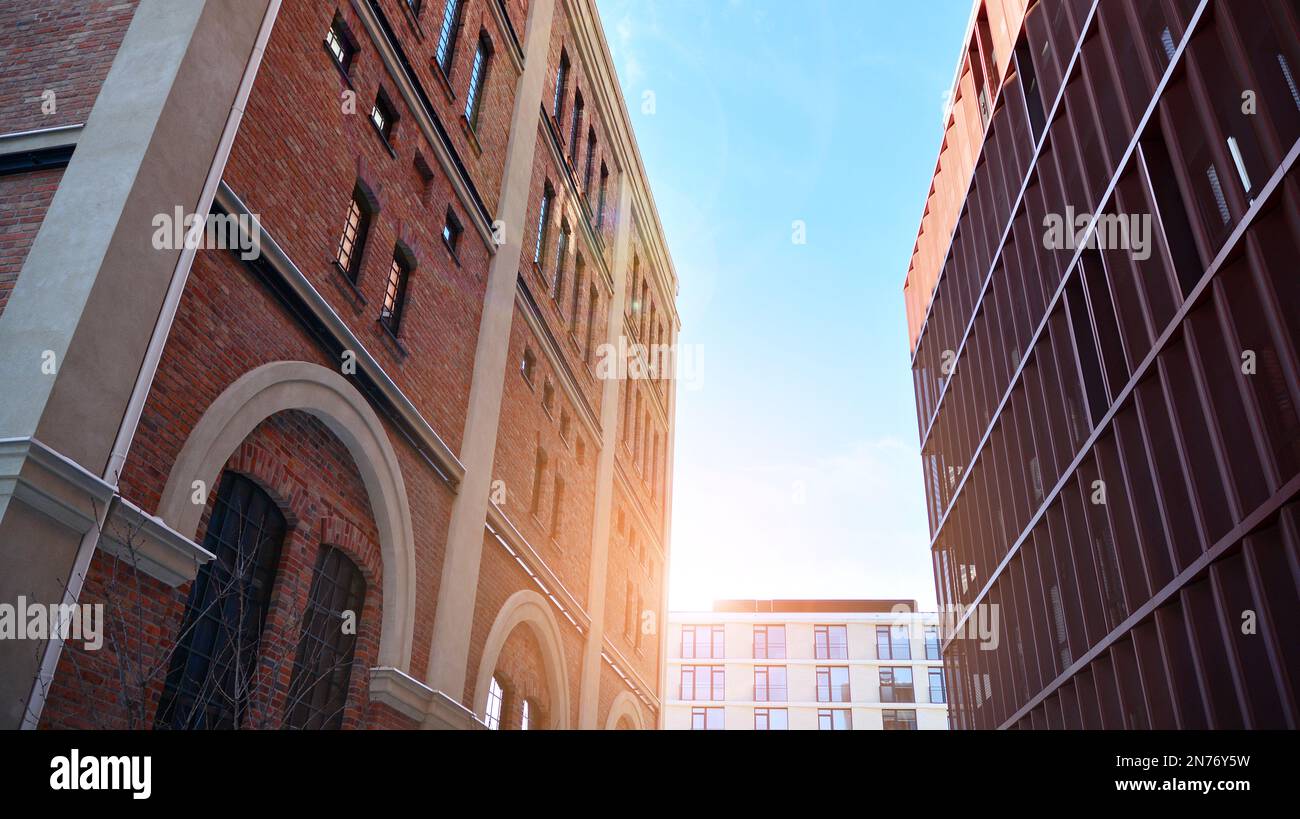 Revitalized red brick building and modern office building. Rising sun ...