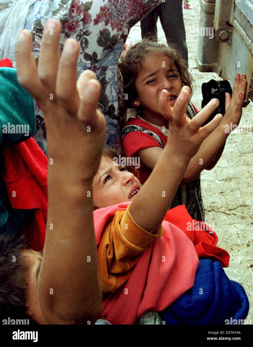 Homeless Turkish children ask for clothes from an aid distribution ...