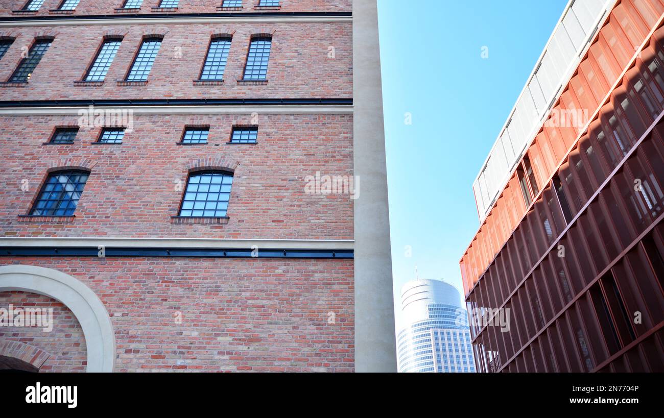 Revitalized red brick building and modern office building. Rising sun ...
