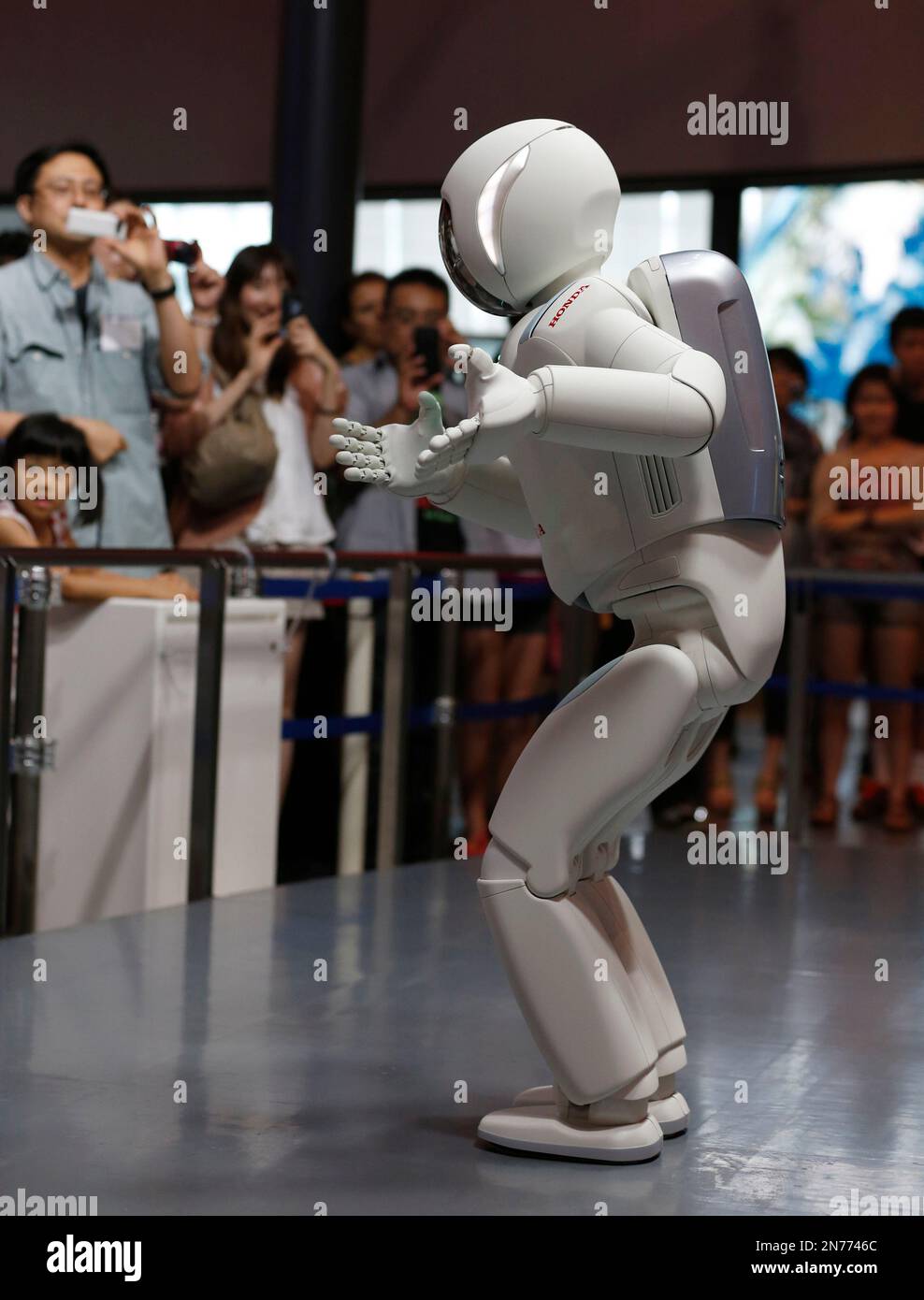 Honda Motor Co.’s interactive robot Asimo gestures while talking with ...
