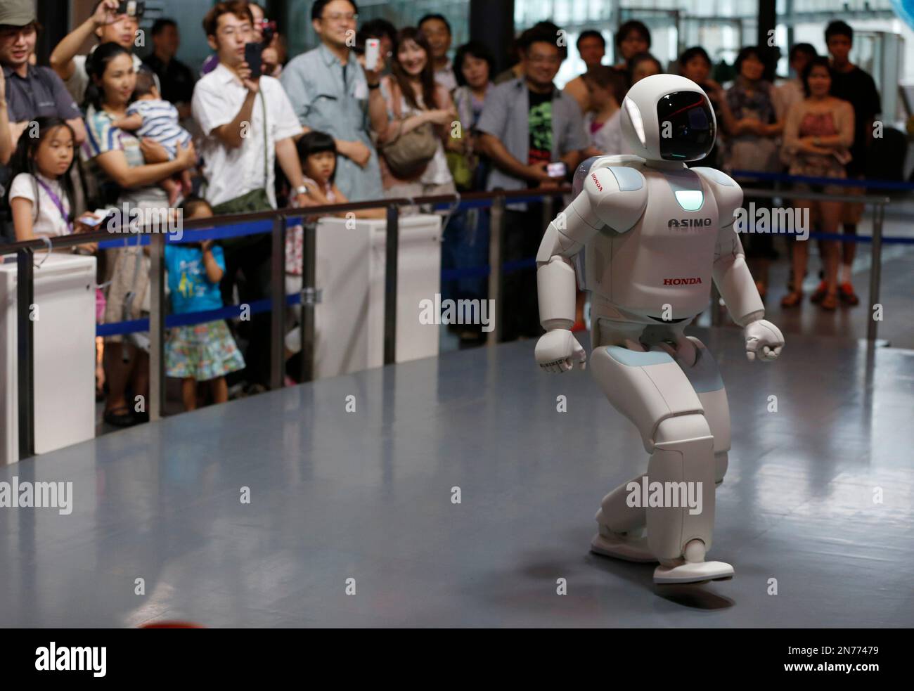 Honda Motor Co.’s interactive robot Asimo leaves a demonstration event ...