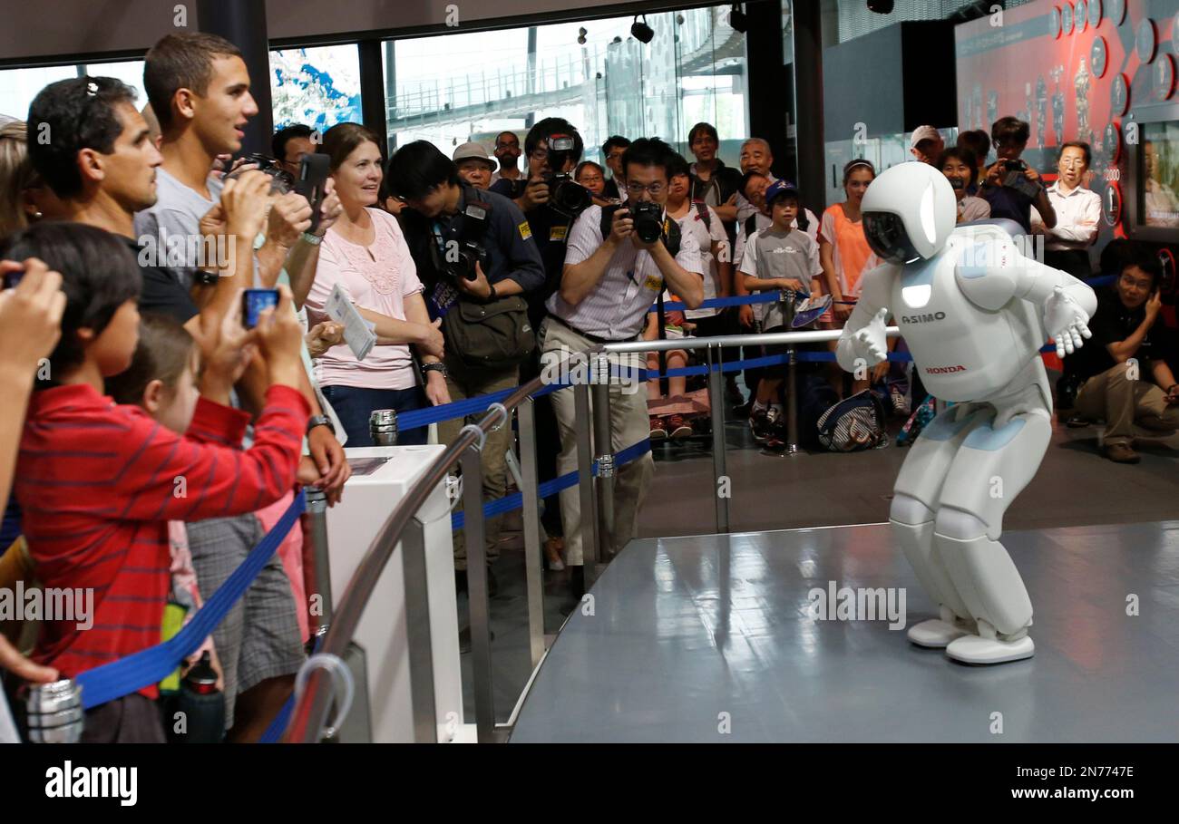 Honda Motor Co.’s interactive robot Asimo gestures while talking with ...