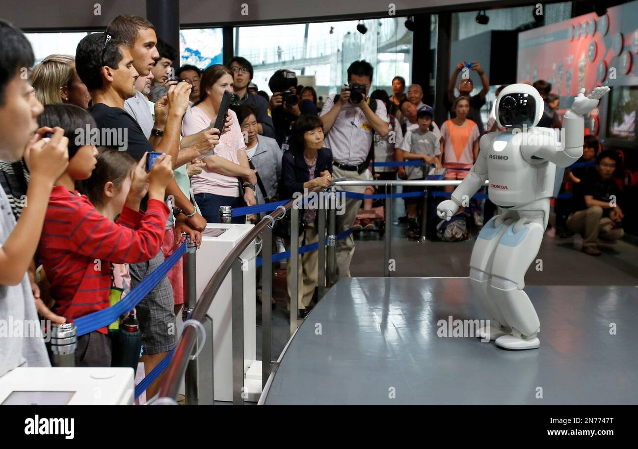 Honda Motor Co.’s interactive robot Asimo gestures while talking with ...