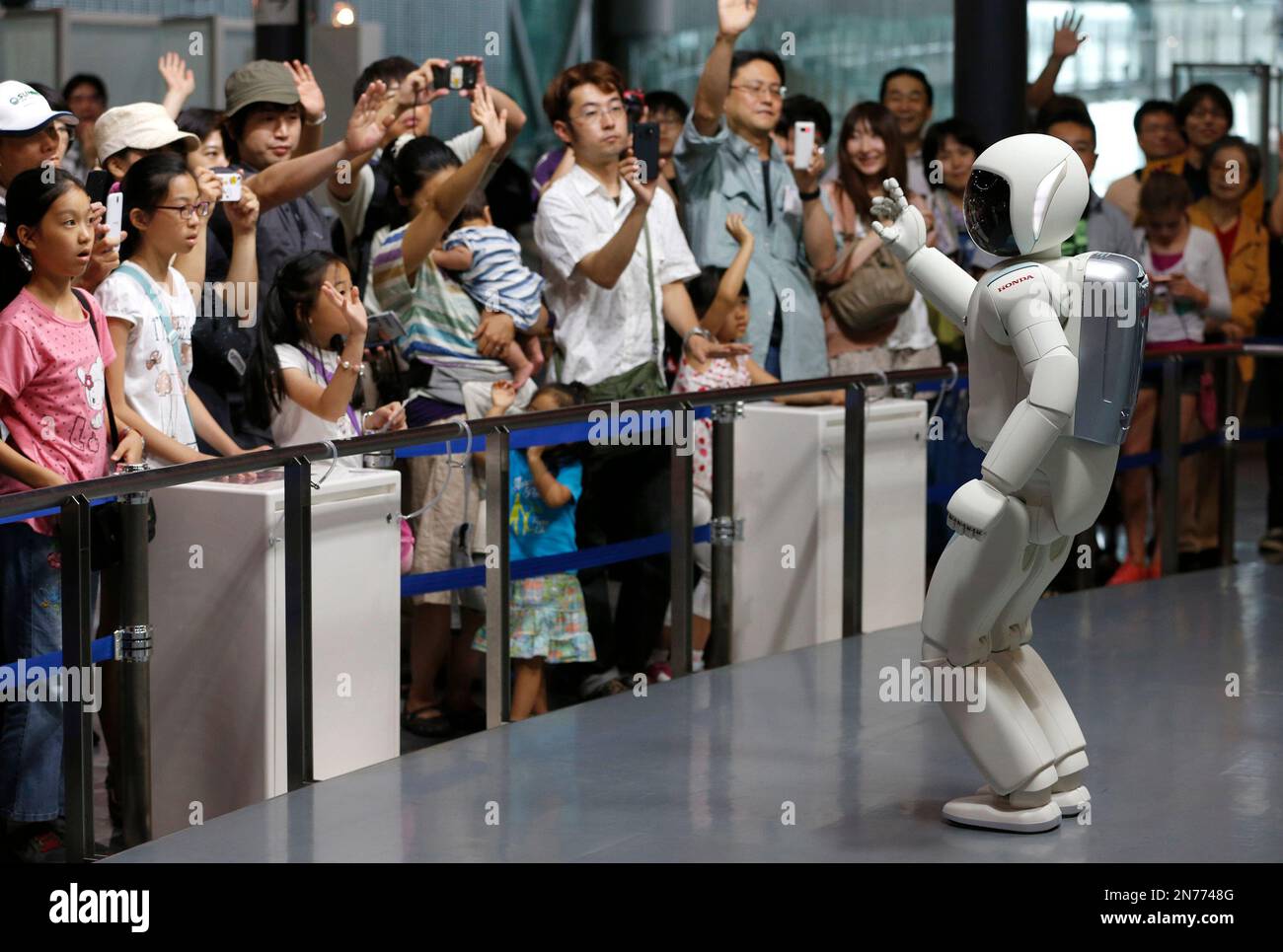 Honda Motor Co.’s interactive robot Asimo gestures while talking with ...