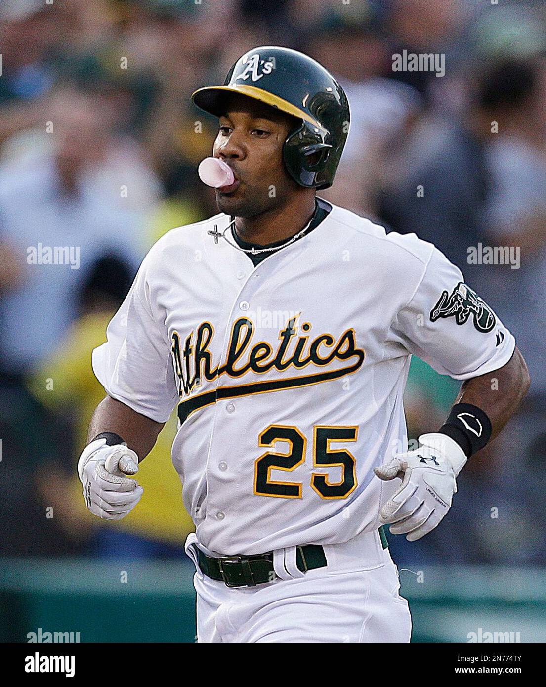 Oakland Athletics' Chris Young blows a bubble as he crosses home plate ...