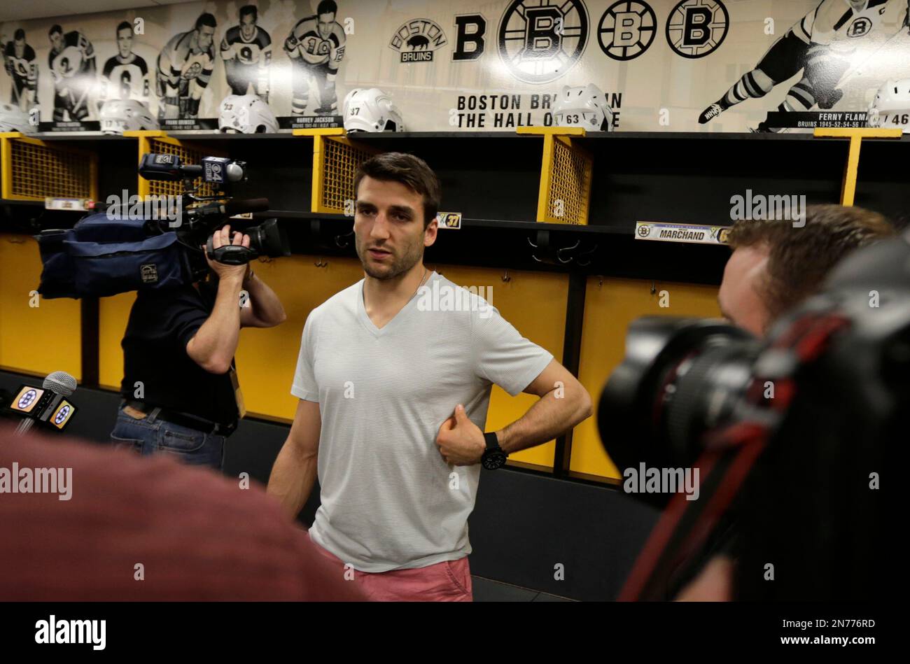 Boston Bruins center Patrice Bergeron gestures towards a broken rib on ...