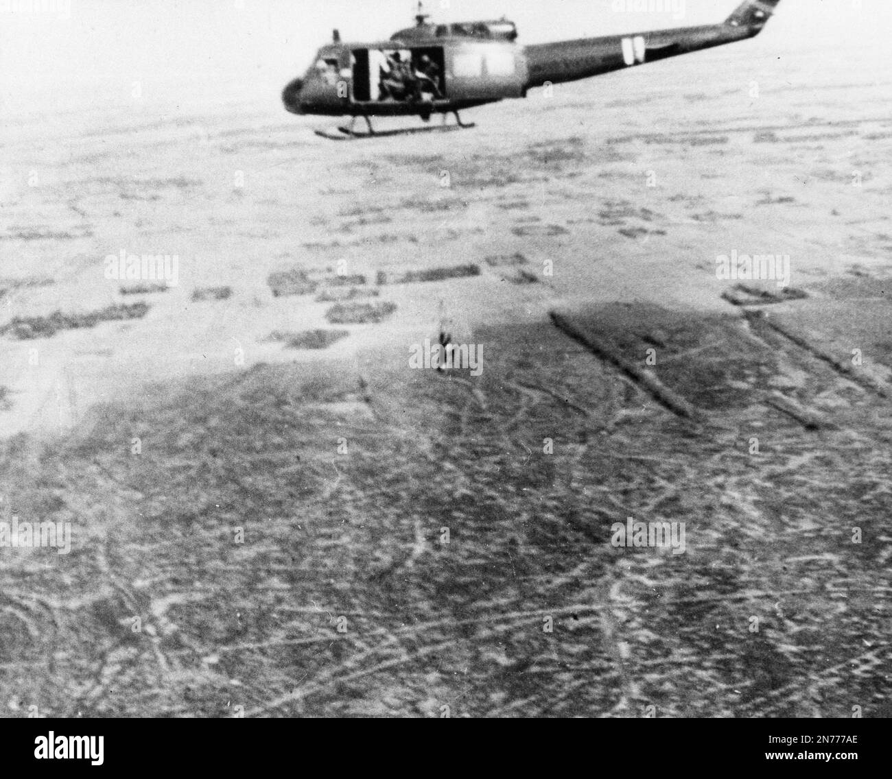A Vitenamese prisoner of ear dangling from a U.S. Army helicopter ...