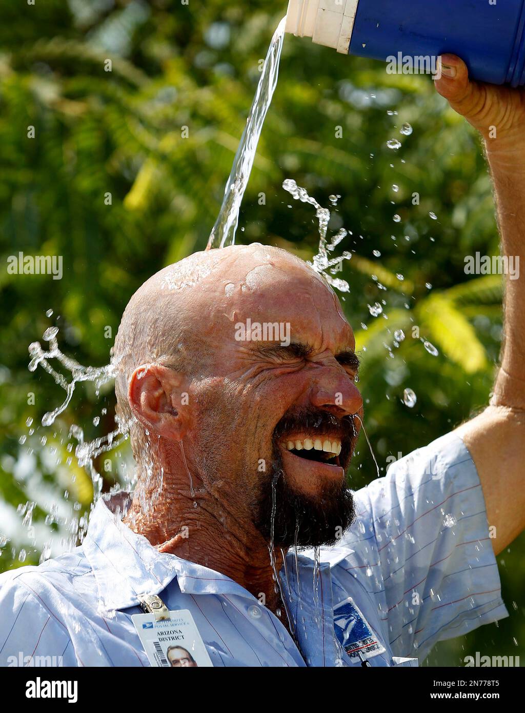 United States Postal Service letter carrier Brian Johnson, 55, pours ...
