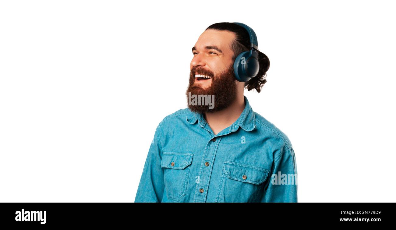 Banner size shot over white background of an ecstatic man laughing and ...