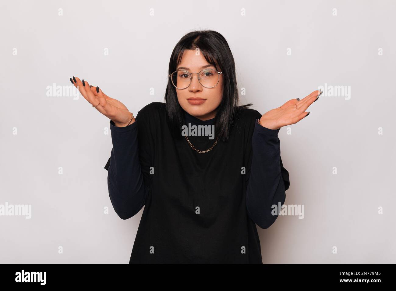 Young gorgeous woman wearing black is shrugging because she does not ...