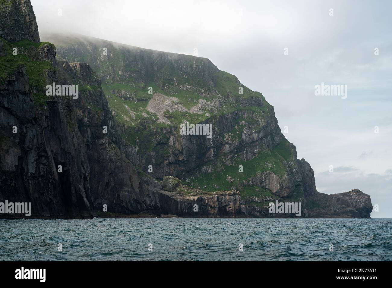Towering rocky sea cliffs on Hirta, the main St Kilda island, seen from ...