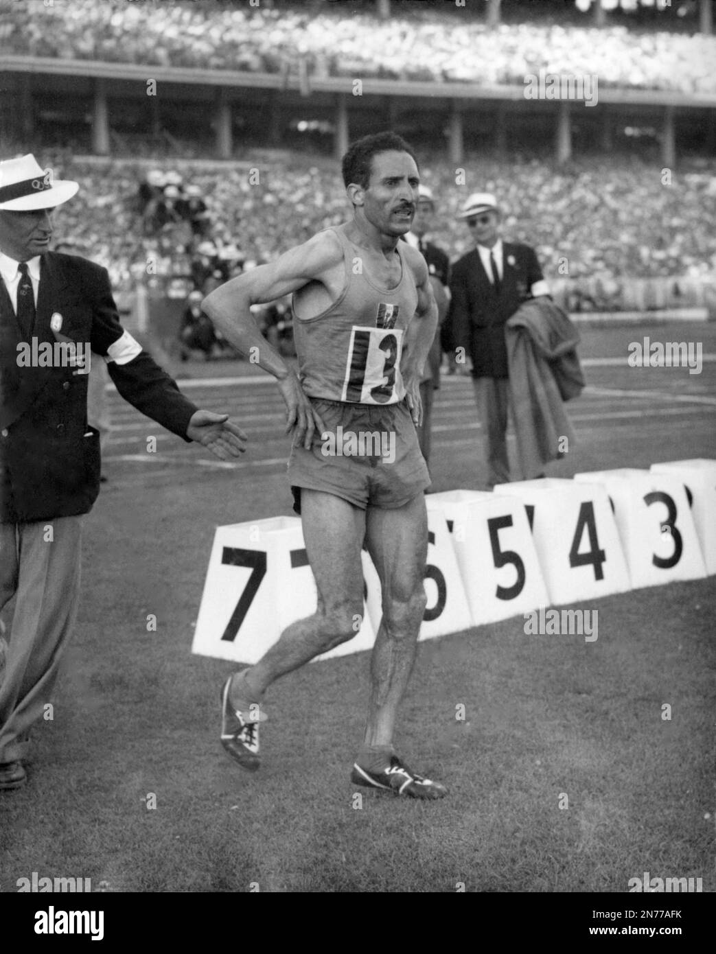 Alain Mimoun of France comes off the track after winning the Men's ...