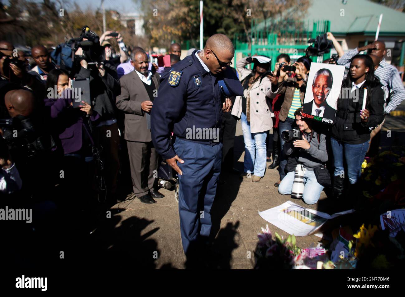 A police officer pays tribute to former South African President Nelson ...