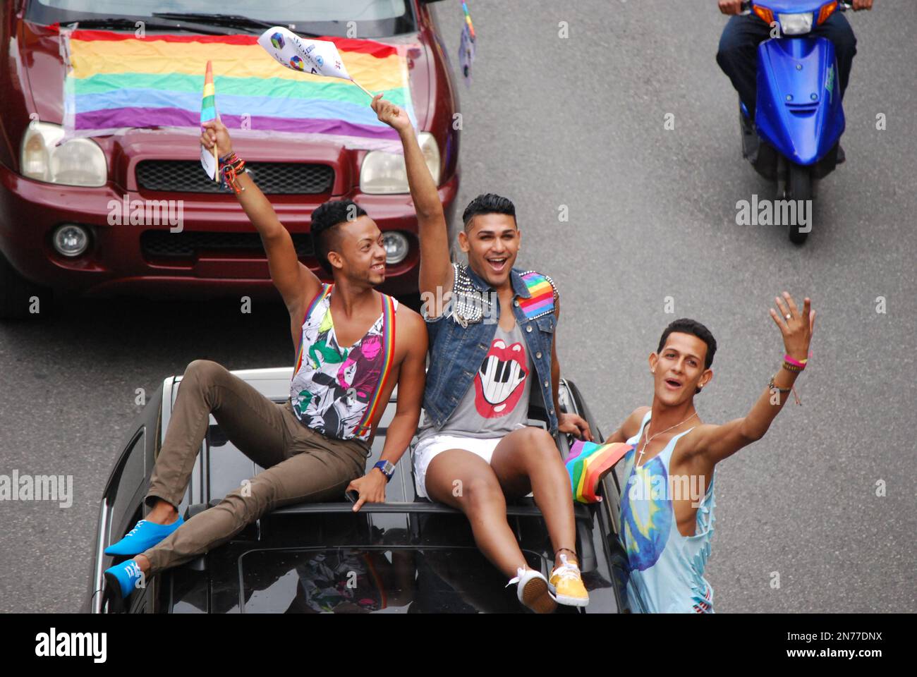 People ride on top of a car during the gay pride parade in Santo ...