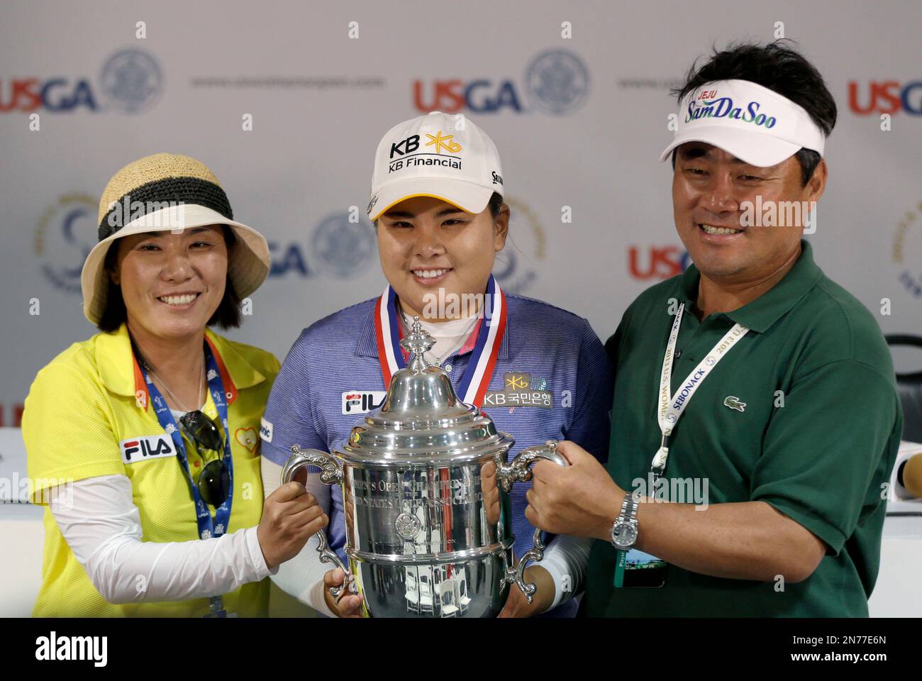Inbee Park, of South Korea, center, poses for a picture with her trophy ...