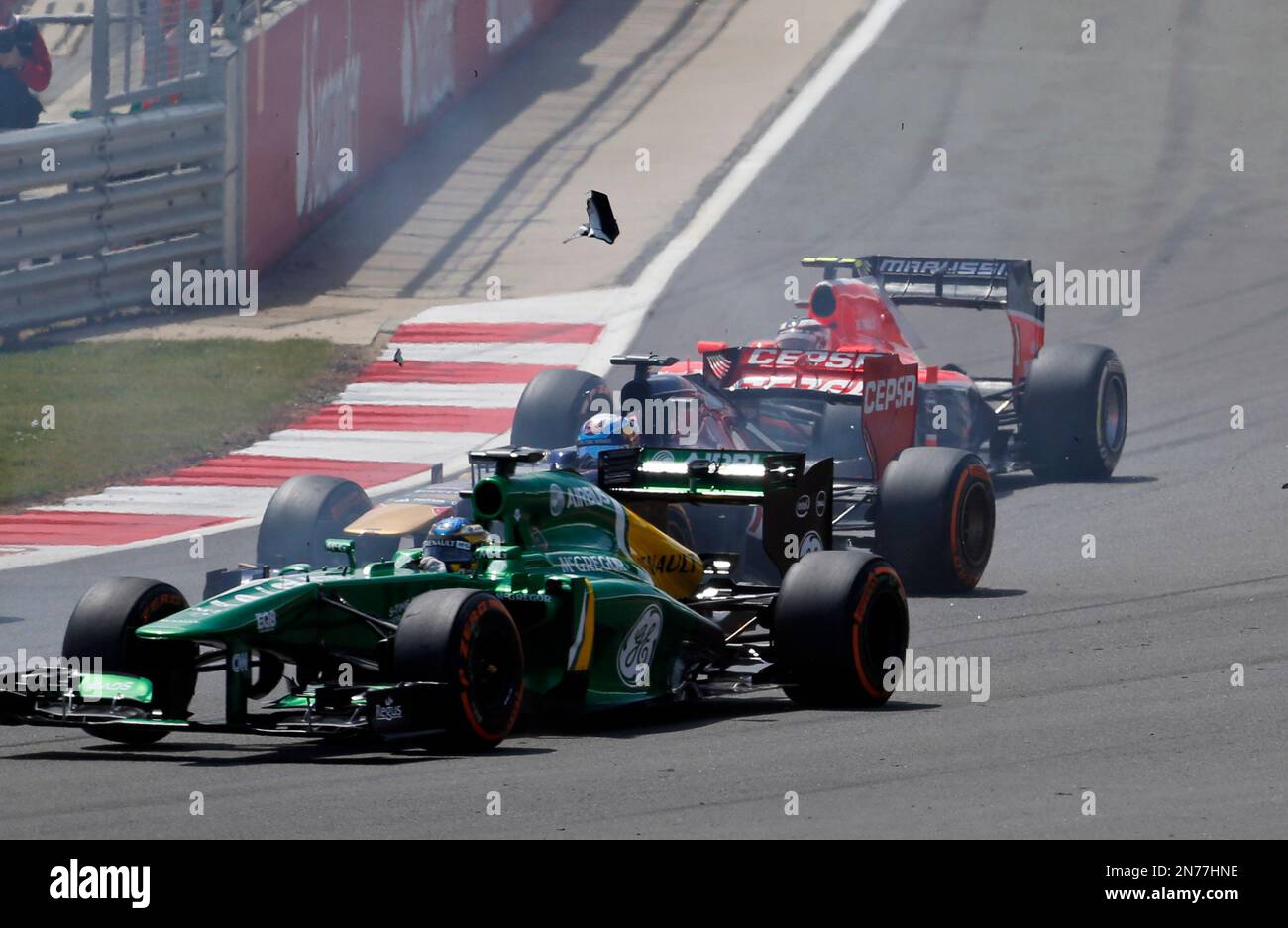 Debris from a car are spread in the circuit as the pack races into the ...