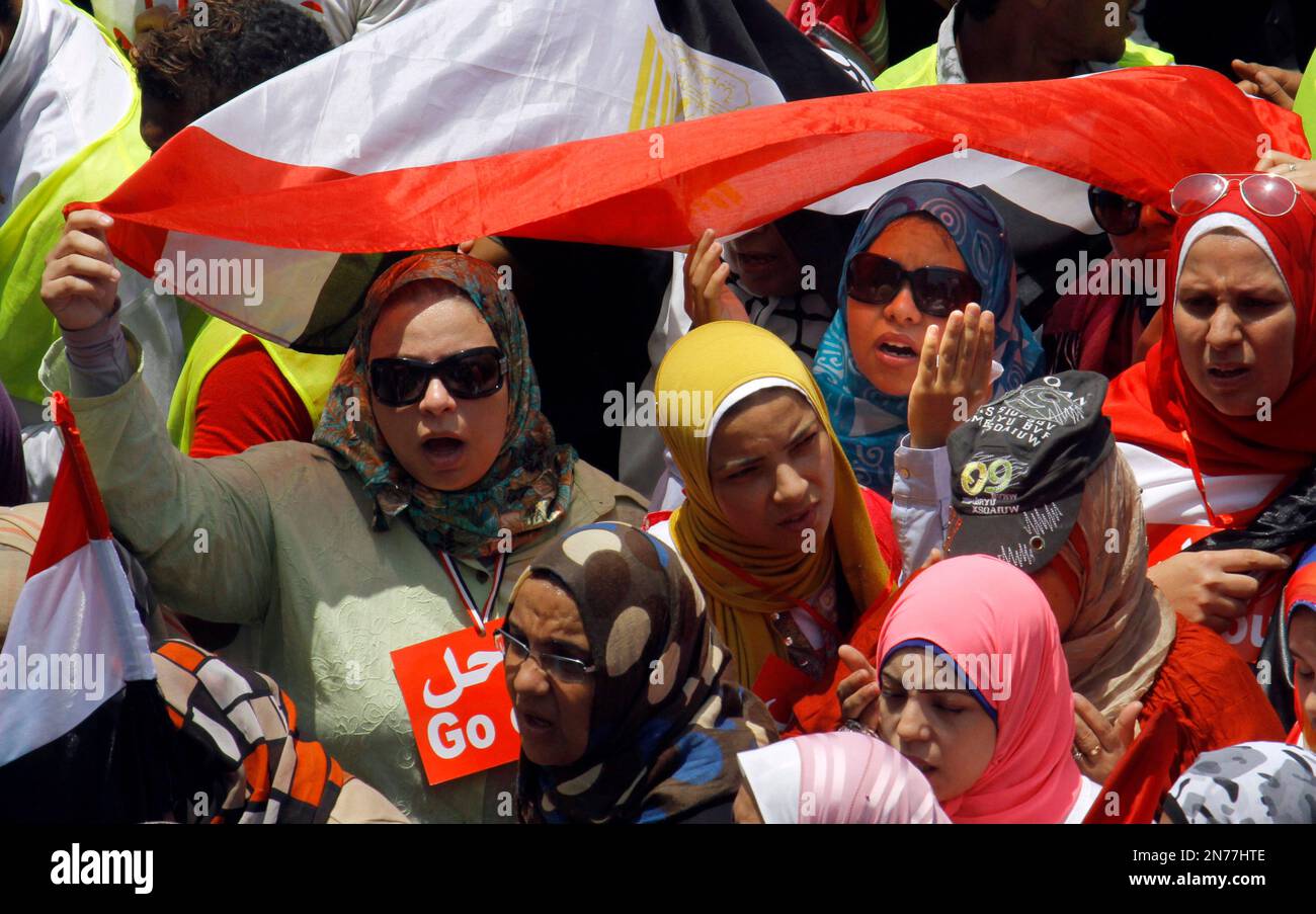 Egyptian protesters pray the noon prayer under a national flag during a ...