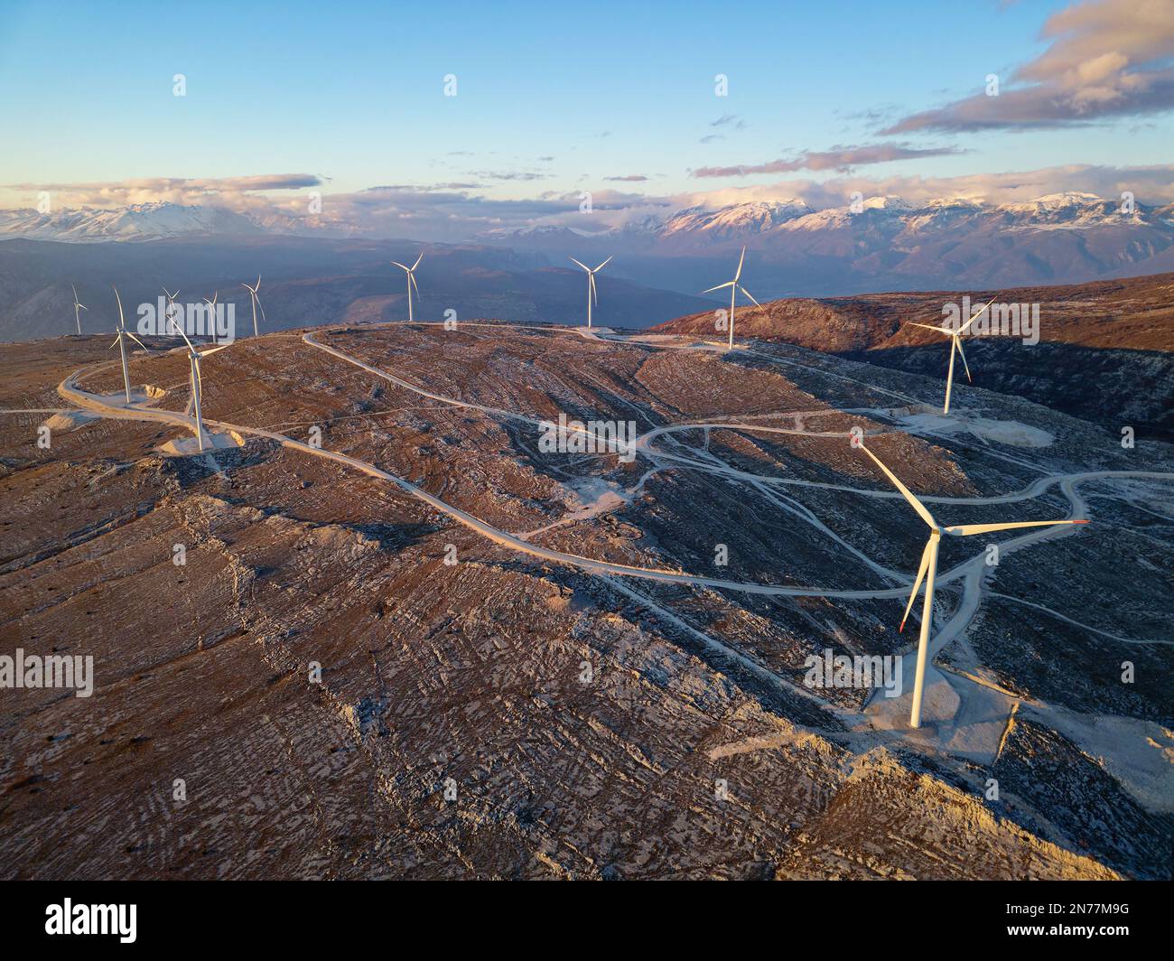 Windmills on the hills during sunset. Renewable energy, green energy ...
