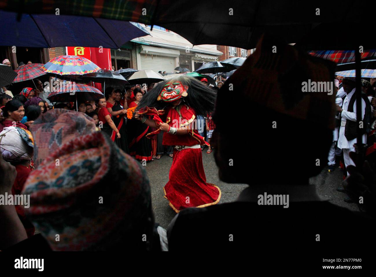 A masked dancer performs during the paddy plantation day at Bhaktapur ...
