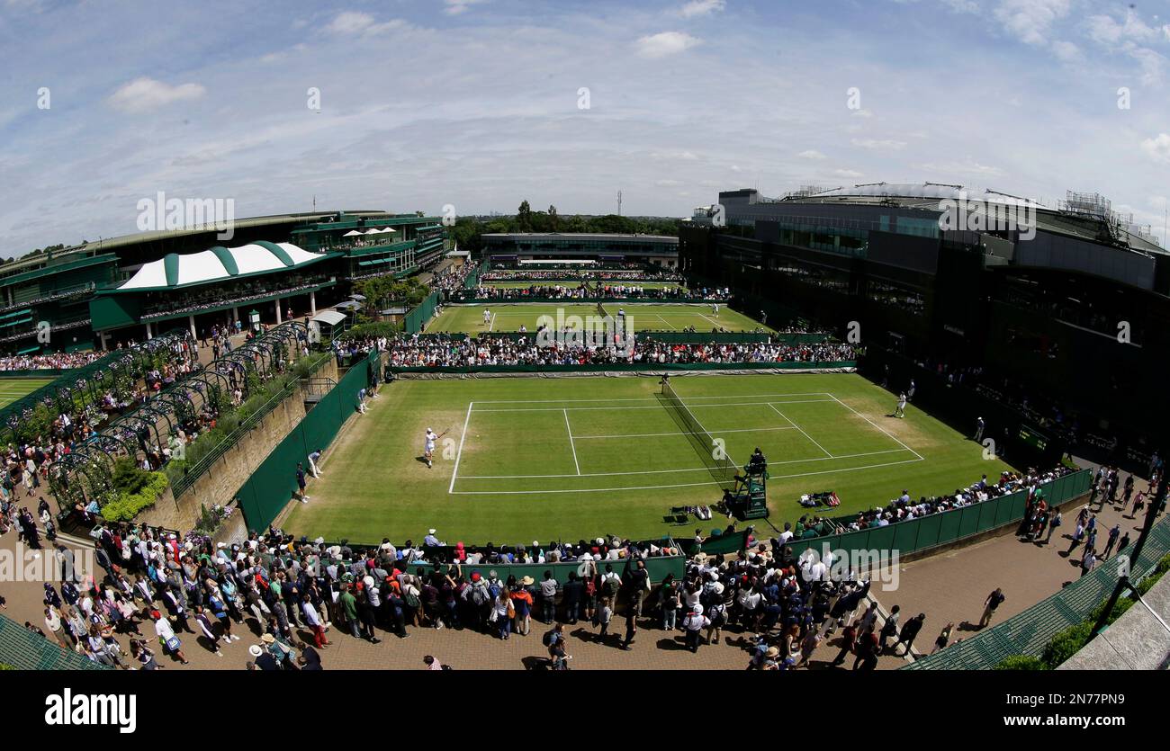 In this photo taken with a fisheye lens, spectators watch play at the ...