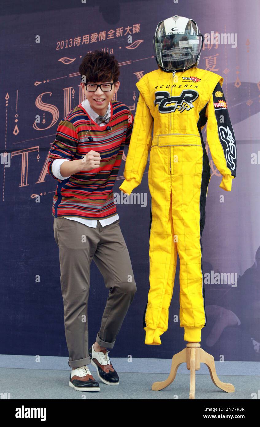 Chinese singer Hu Xia poses with his gift during a media event ...