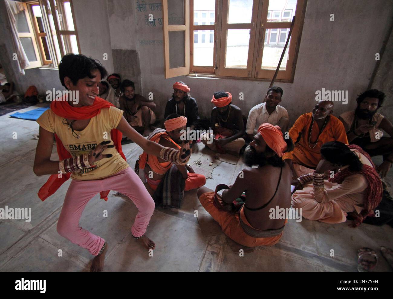 A eunuch dances as Hindu holy men wait to register for the annual ...