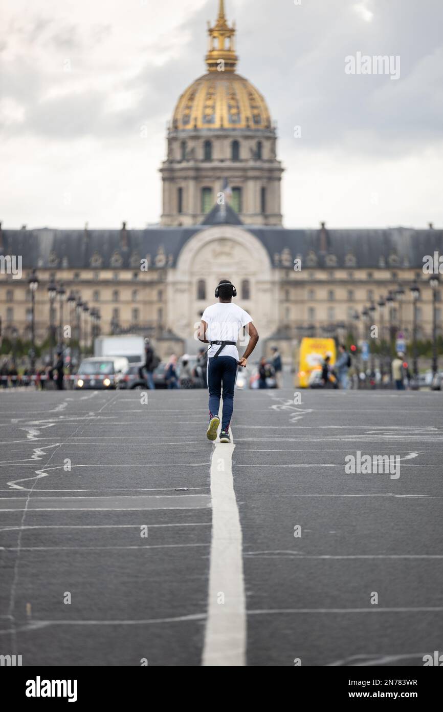 An African-American male running in the middle of the street in Paris ...