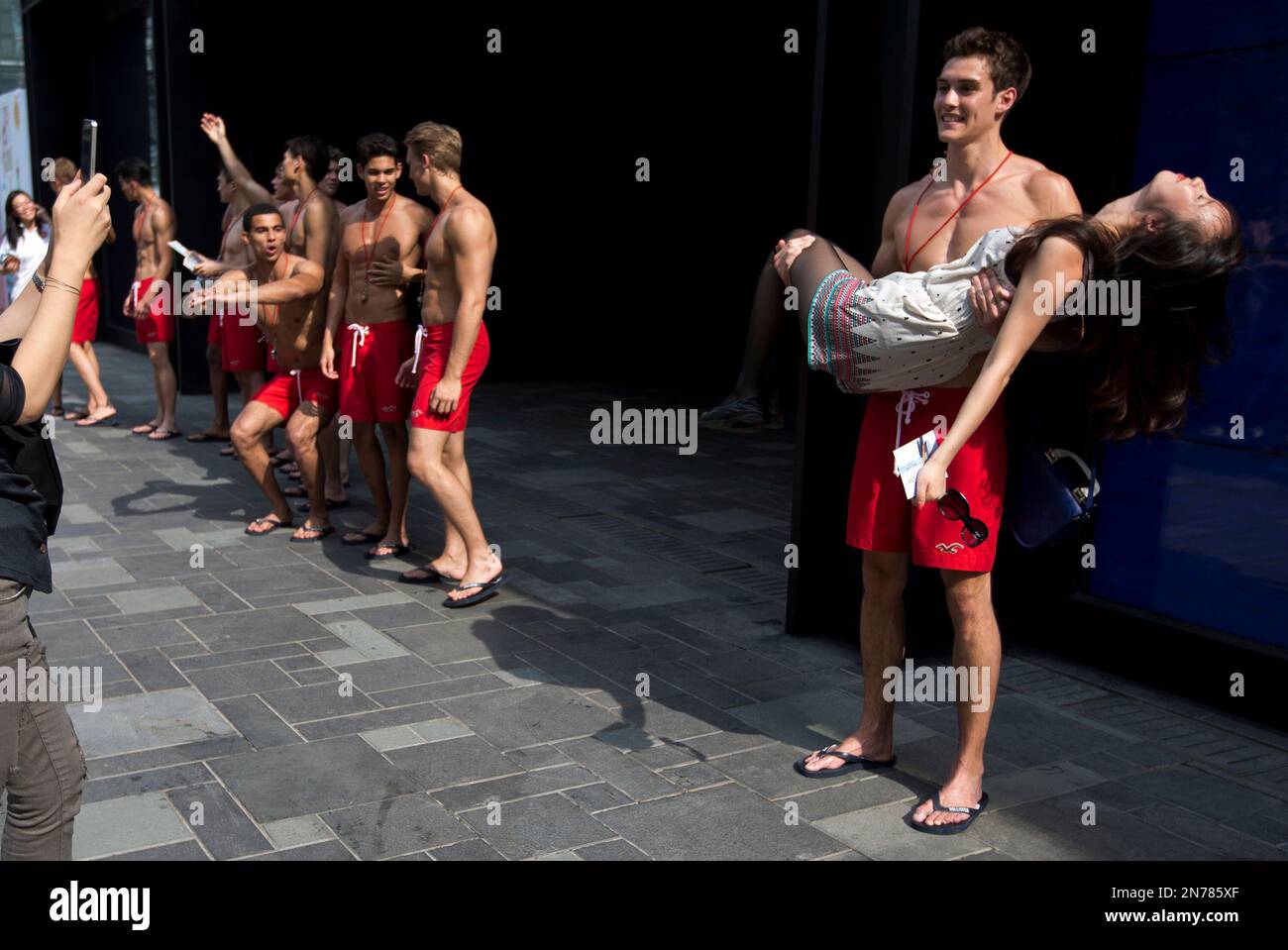 A Chinese women acts fainted as she poses a photo session with a ...