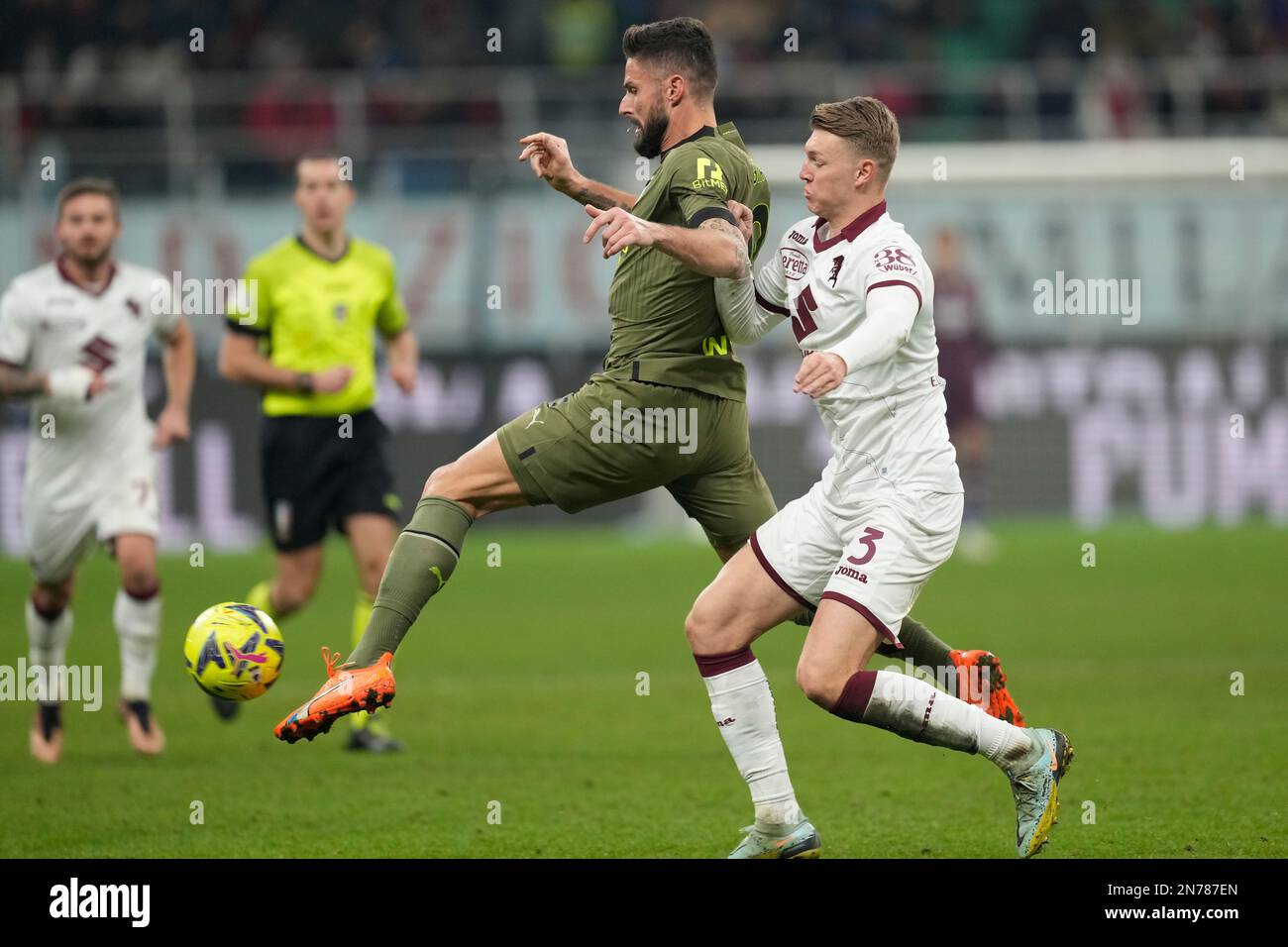 AC Milan's Olivier Giroud, centre, is challenged by Torino's Perr Schuurs during the Italian ...