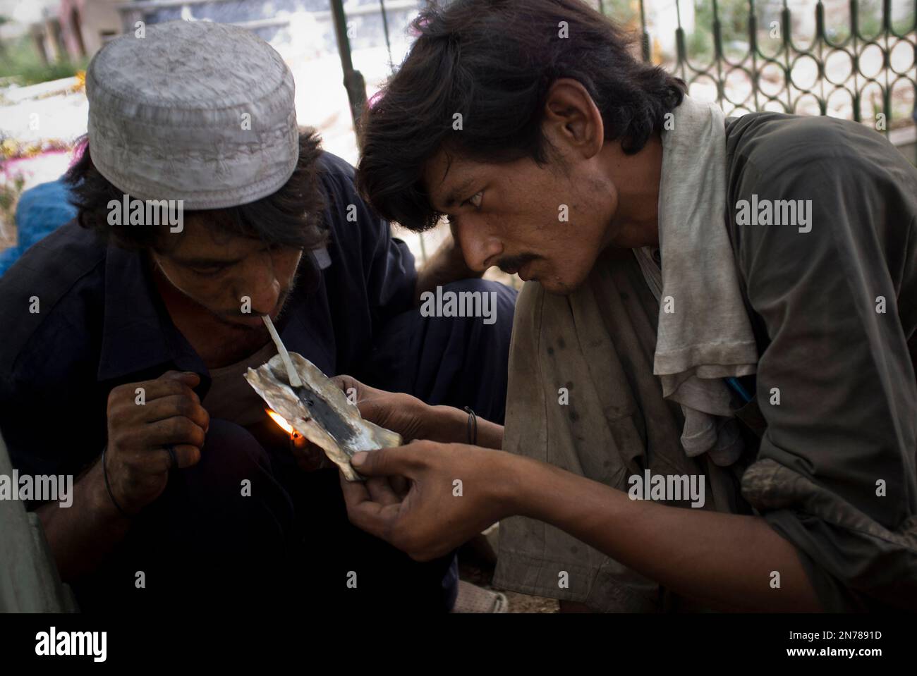Pakistani drug addicts inhale drug smoke in Rawalpindi, Pakistan on ...