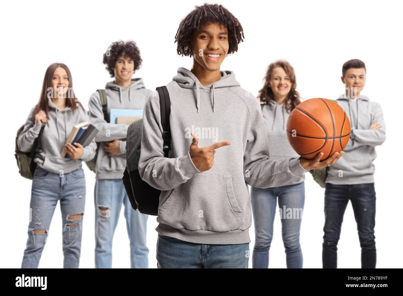 African american male student holding a basketball and pointing and ...