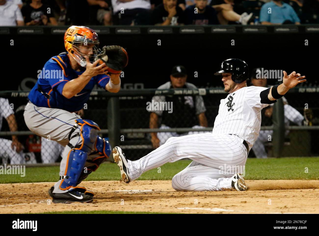 Chicago White Sox's Tyler Flowers, right, scores on an Alexei Ramirez ...