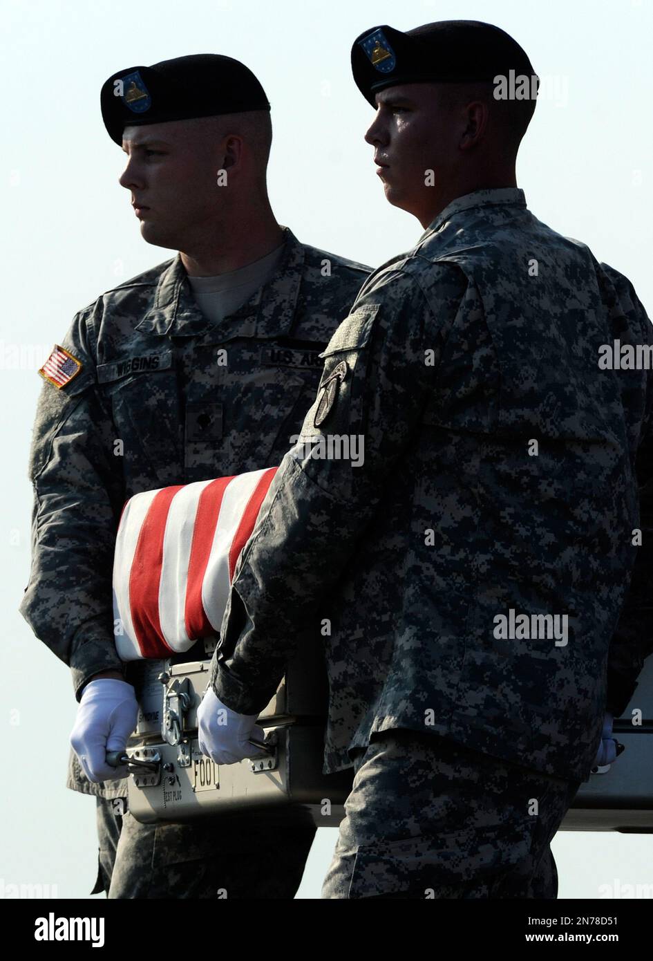 An Army carry team moves a transfer case containing the remains of Spc ...