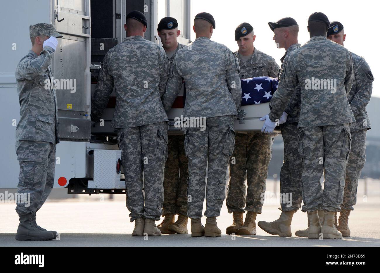An Army carry team moves a transfer case containing the remains of Sgt ...