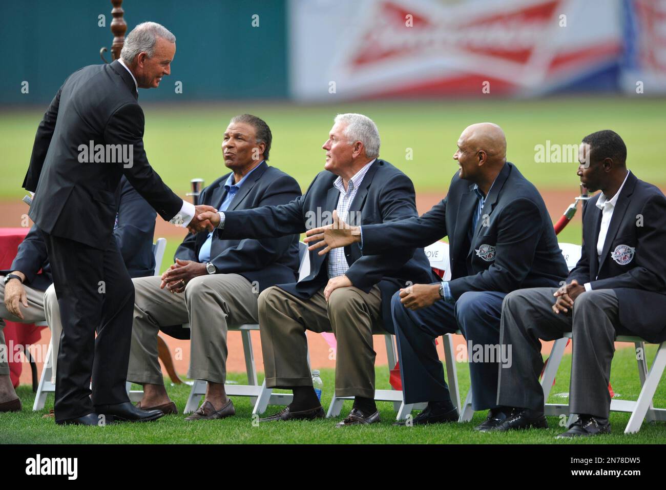 Former Cleveland Indians general manager John Hart, left, shakes hands ...