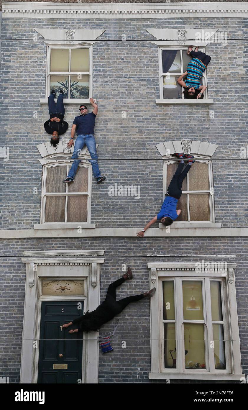 Visitors enjoy an art installation by Argentinan artist Leandro Erlich ...