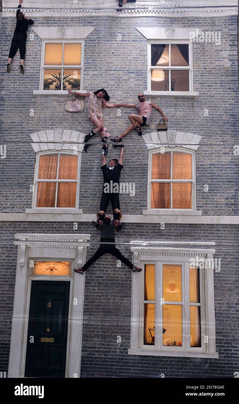 Guests playing with illusion on Leandro Erlich's installation Dalston ...