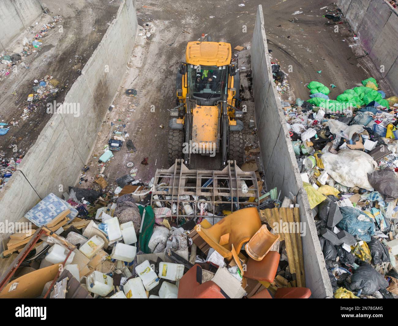 Front loader with scrap handling grapple bucket moving forward and ...